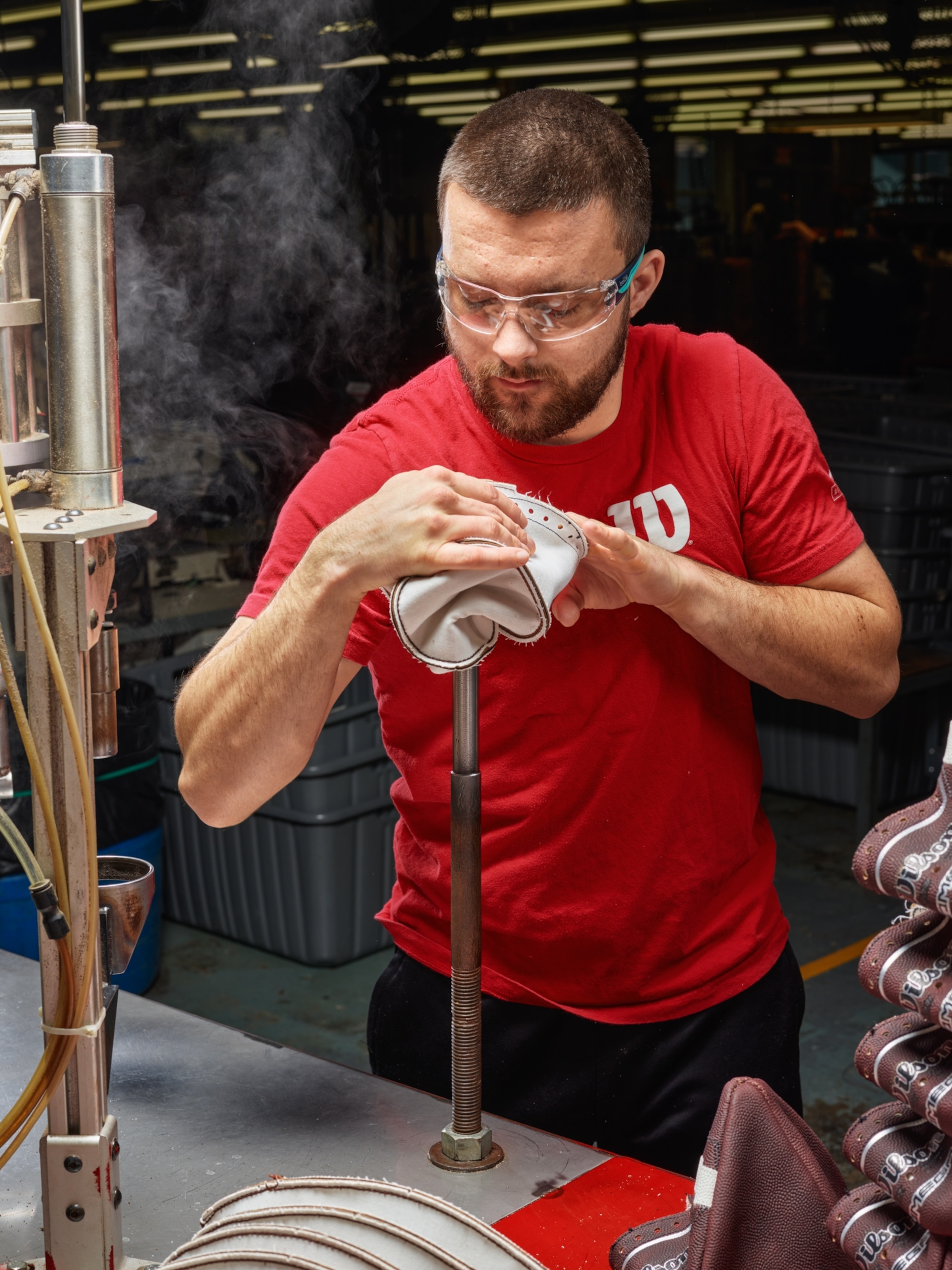 Step inside the factory where the NFL’s footballs are made