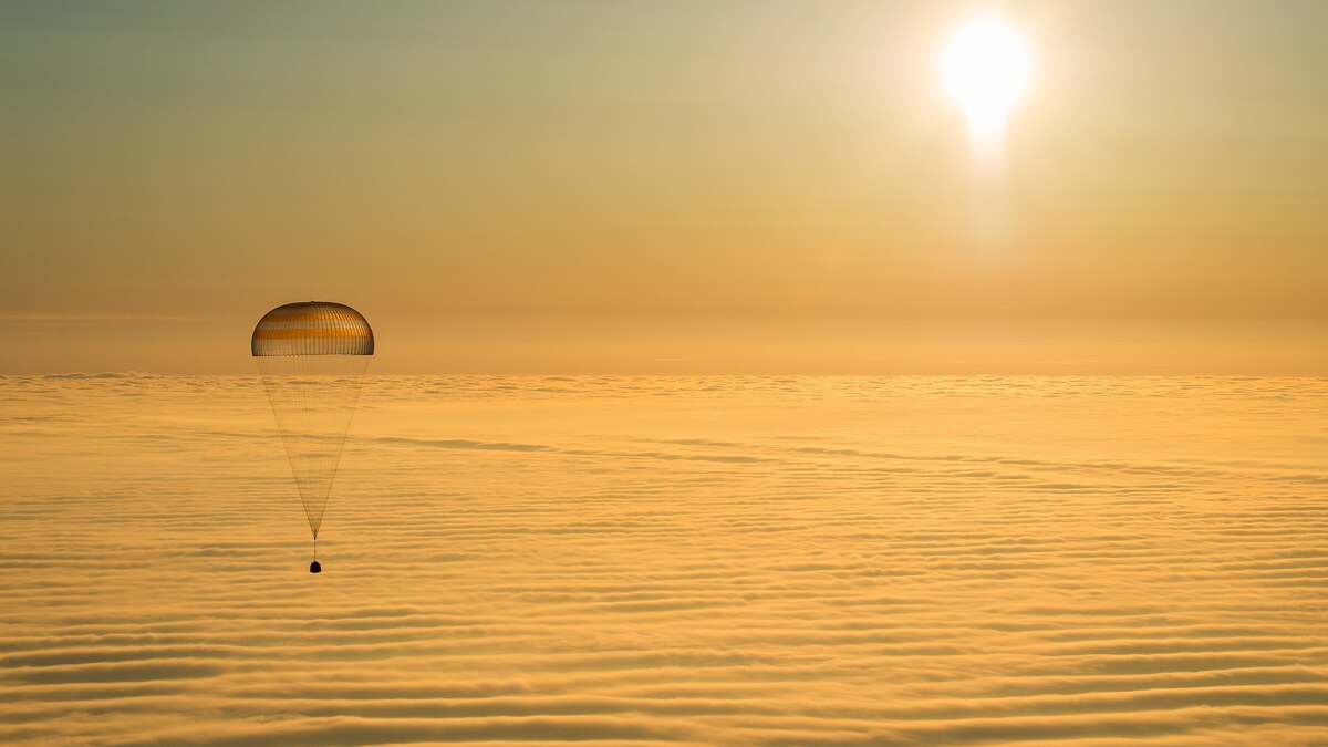 Space Station Astronauts Float to Earth in Golden Parachute | National ...