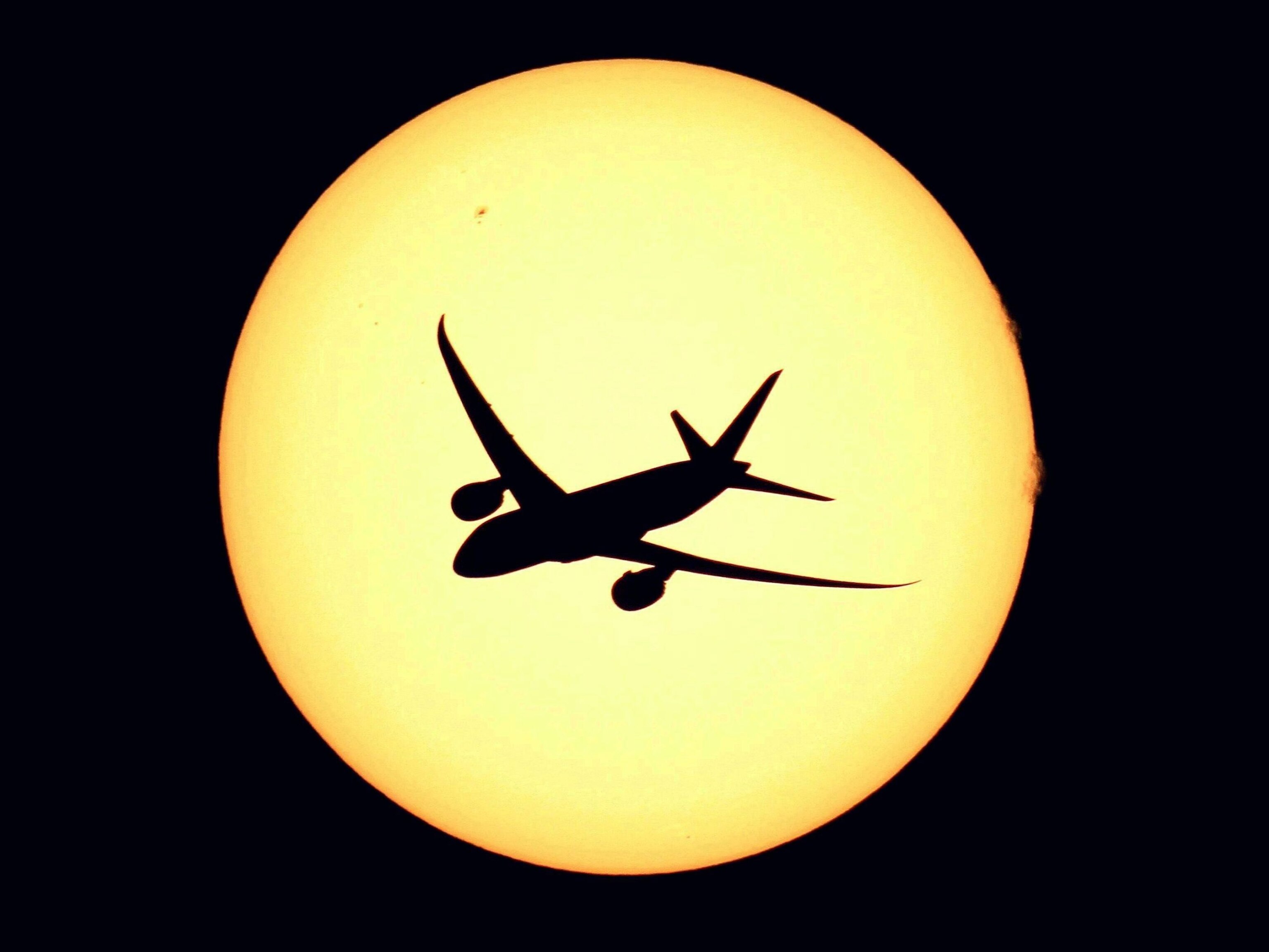 Dreamlike Photos of Planes Flying Past the Sun and Moon